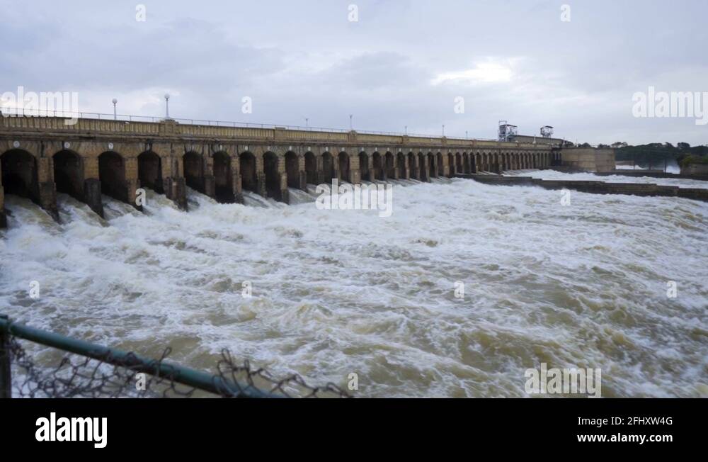A view of a big reservoir with its flood gates open and massive ...