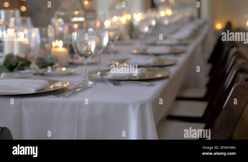 A Long Dinner Table Setup for an Upscale Banquet Inside of a Rustic ...