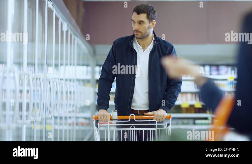 At the Supermarket: Handsome Man Opens Freezer and Places Frozen Items ...