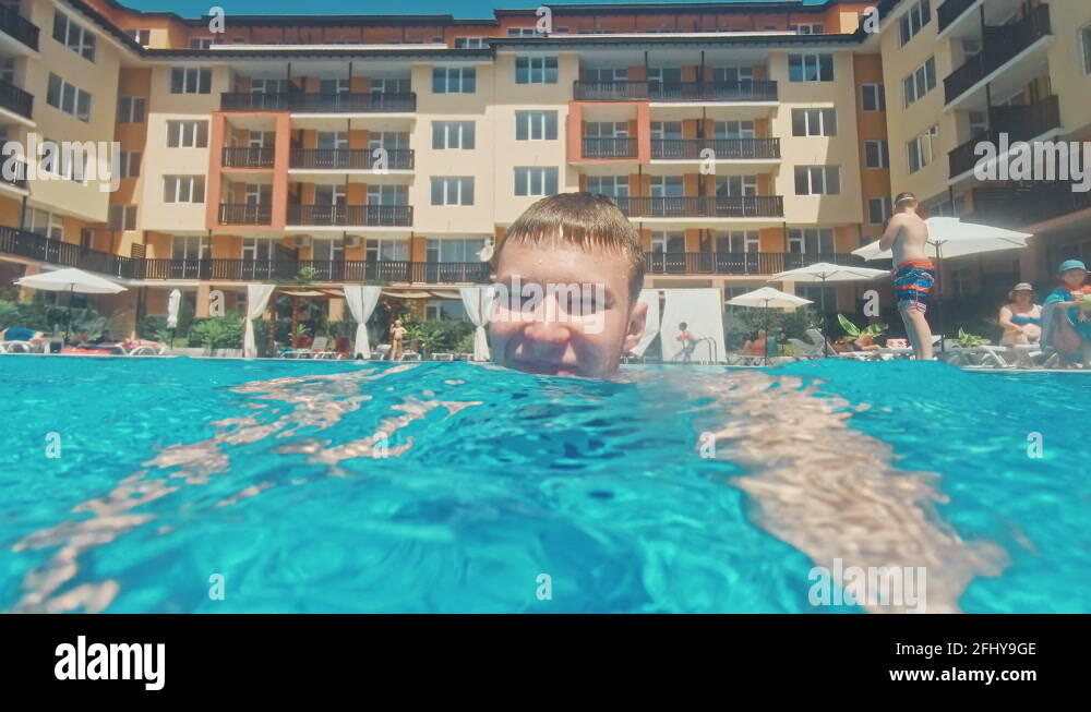 Young guy swims underwater in a swimming pool Stock Video Footage - Alamy