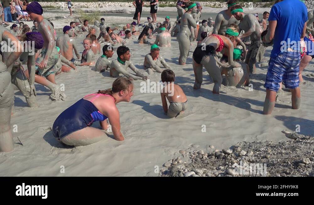 Tourists enjoy natural mud bath Stock Video Footage - Alamy