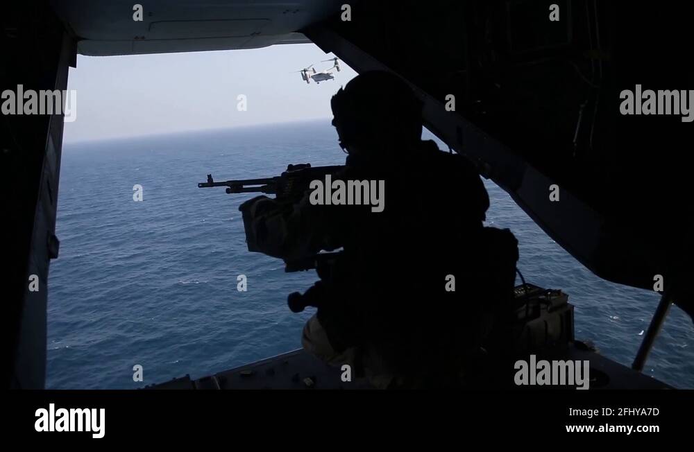 Troops practice shooting M240 machine gun at targets from MV-22B Osprey ...
