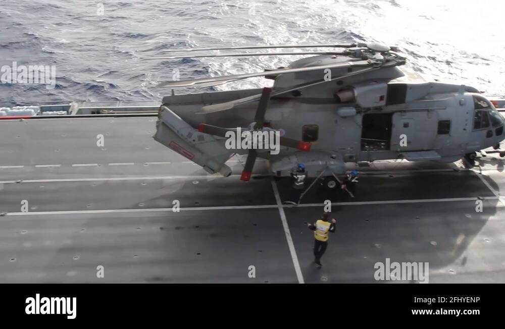 Merlin helicopter raised from hangar of HMS ocean to the flight deck ...