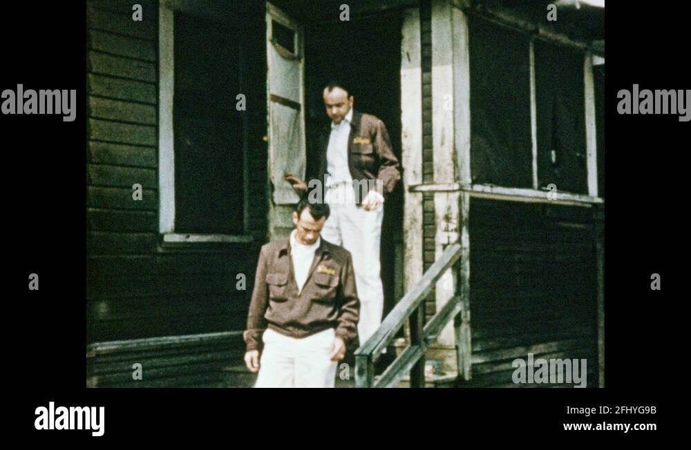 1950s: Men walk out of house. Men load stretcher into ambulance ...