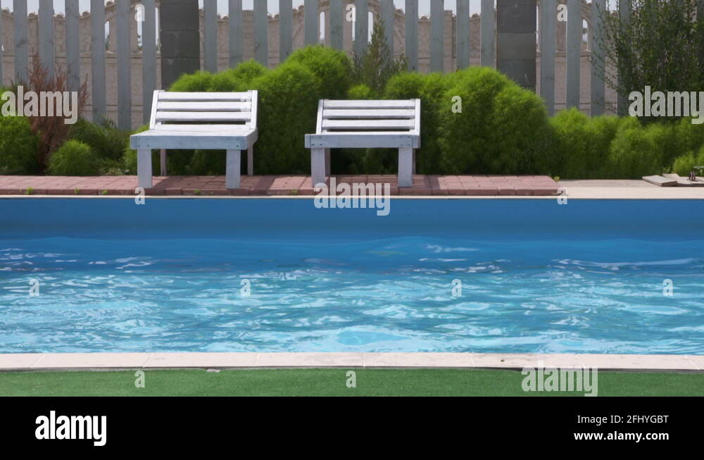 Swimming pool in summer. Young girl in wet swimsuit standing at the ...