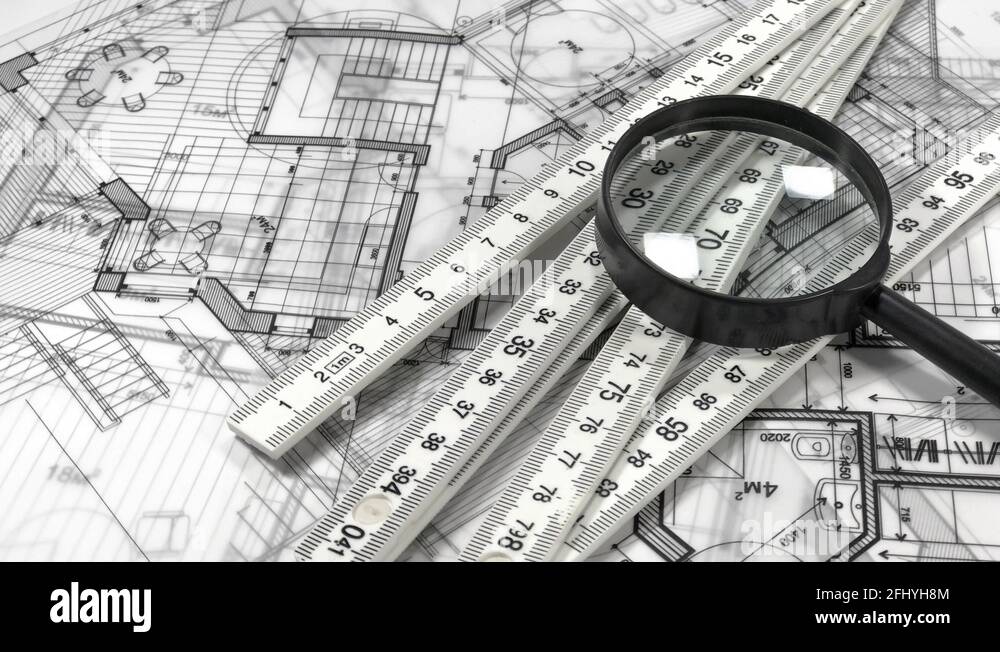 blueprints - architectural drawings, folding ruler and magnifying glass ...