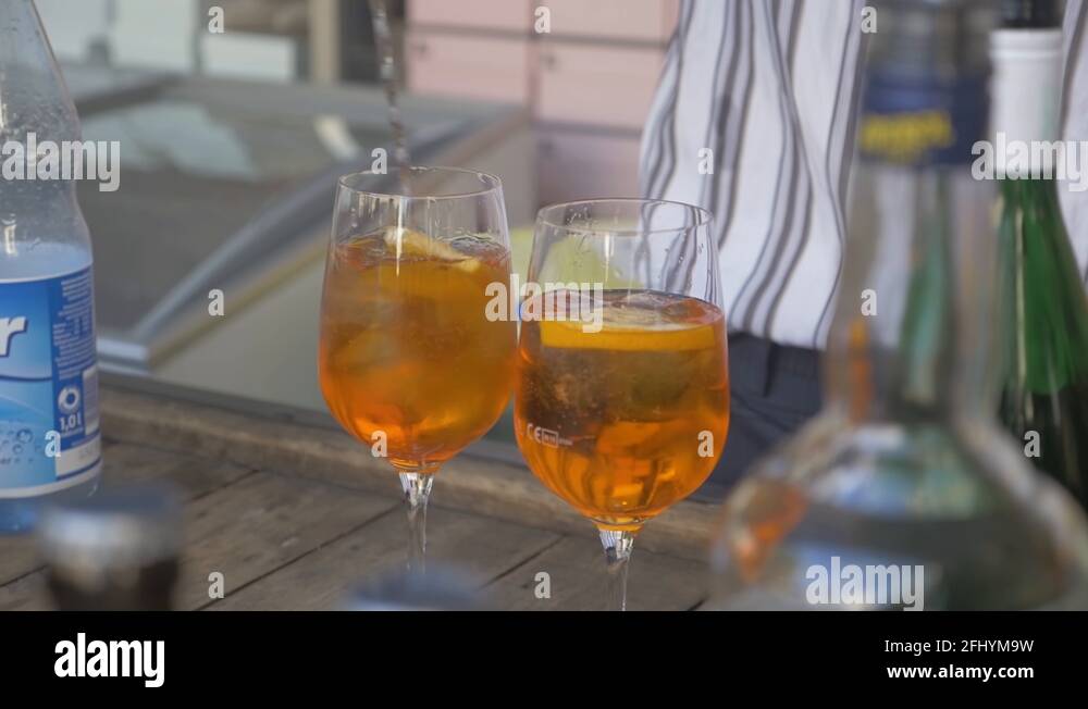 Barkeeper mixing a drink called Aperol spritz. (Mixing with a spoon ...