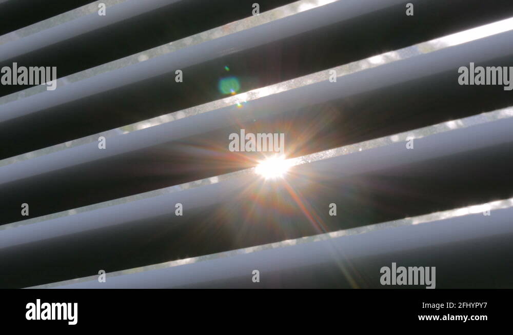 Sun lens flare through window louvers Stock Video Footage - Alamy