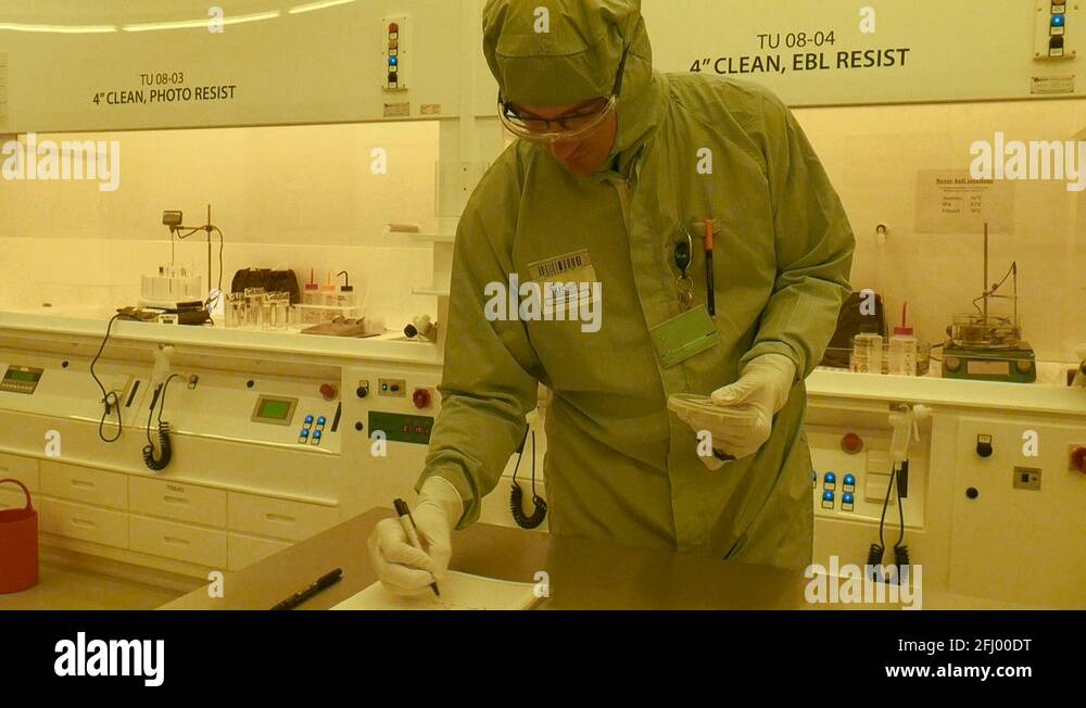 A scientist making notes on his experiments in the clean room or Stock ...
