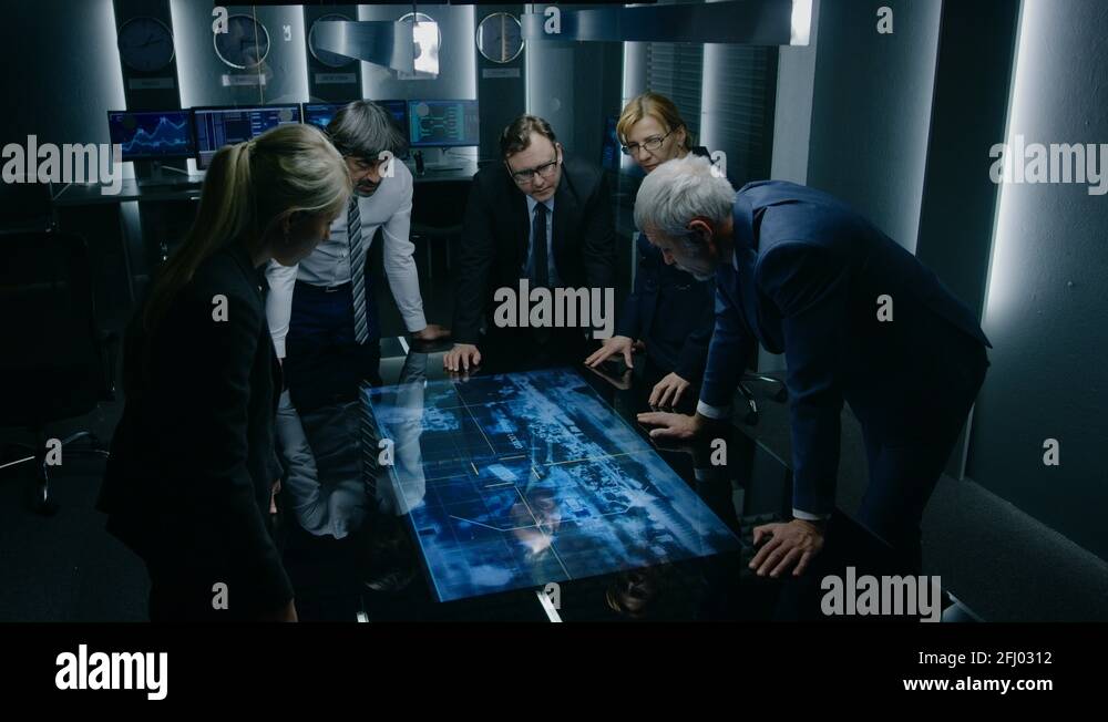 Team of Government Intelligence / FBI Agents Standing Around Digital ...