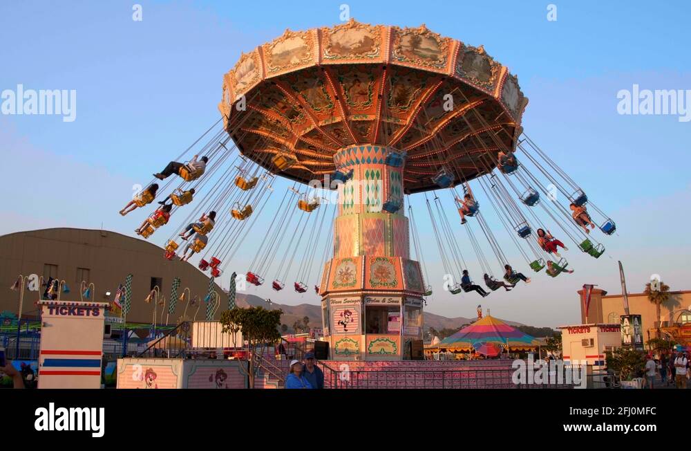 People suspended on swings on a towering, spinning, whirling, thrill ...