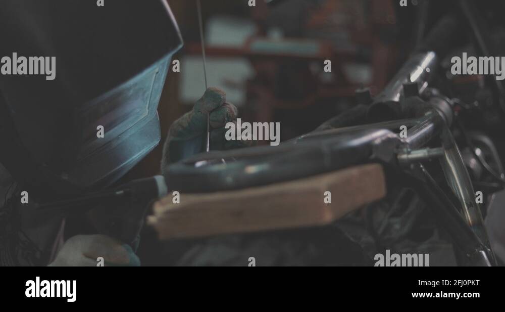 Automaster weld the frame of custom motorcycle Stock Video Footage - Alamy