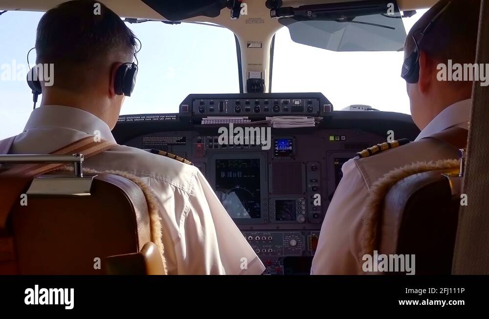 Two Caucasian experienced pilots in the cockpit or on the flight deck ...