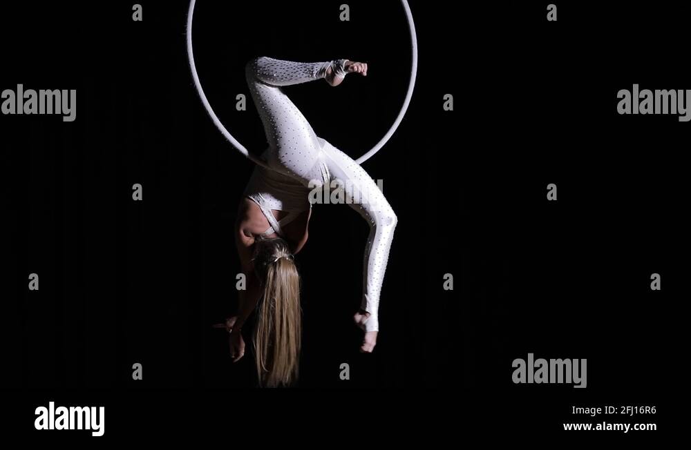 Circus artist make acrobatic trick hanging in ring Stock Video Footage ...