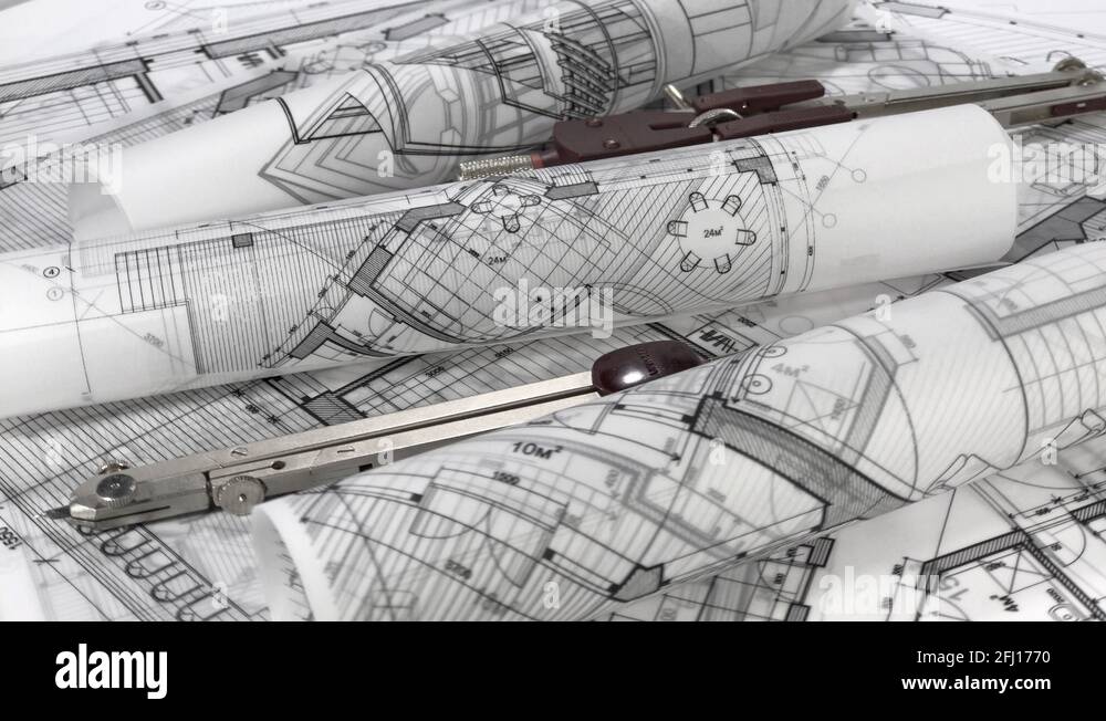 Blueprints - rolls of architectural drawings and compass smoothly ...
