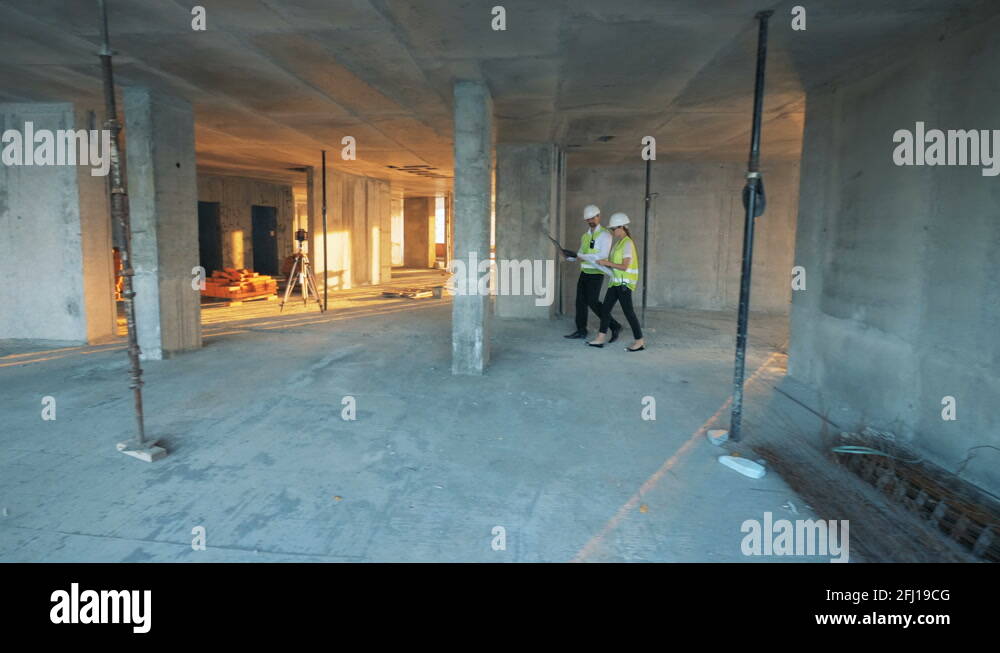 Engineers walk through a building on a construction site Stock Video ...