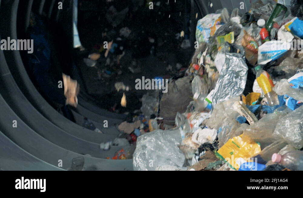 Big equipment sorts trash. Household garbage moves in a special machine ...