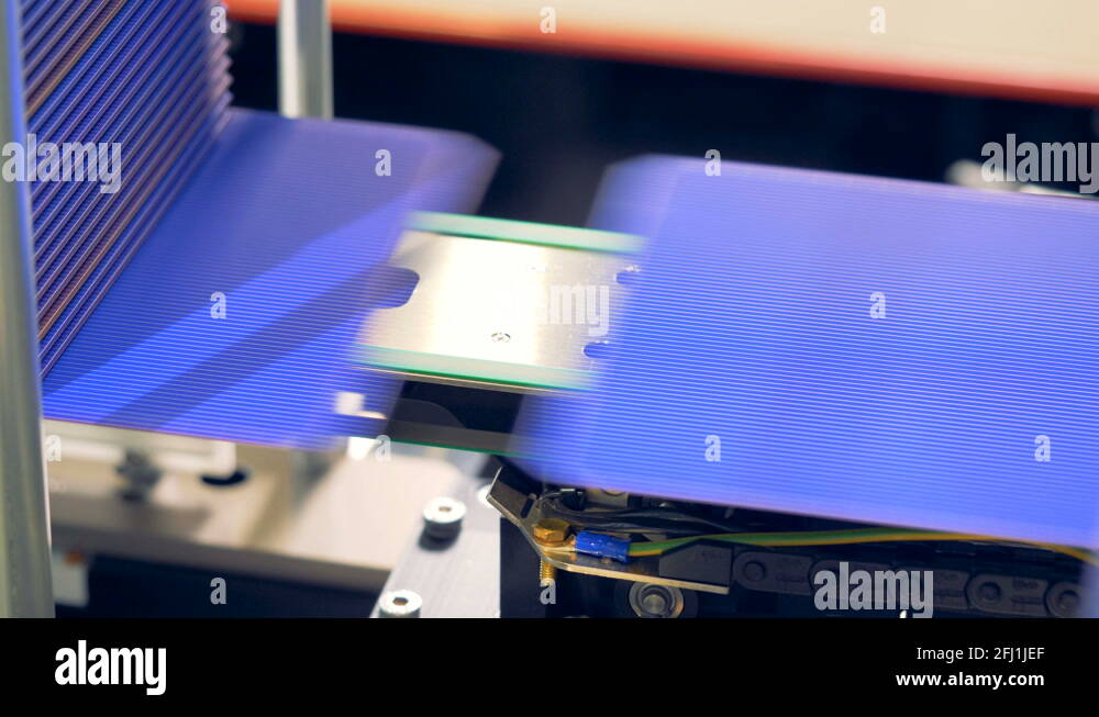 Solar module cells being released and moving along the conveyor belt ...