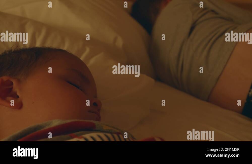 Two tired cute boys sleeping in a soft bed late at night Stock Video ...