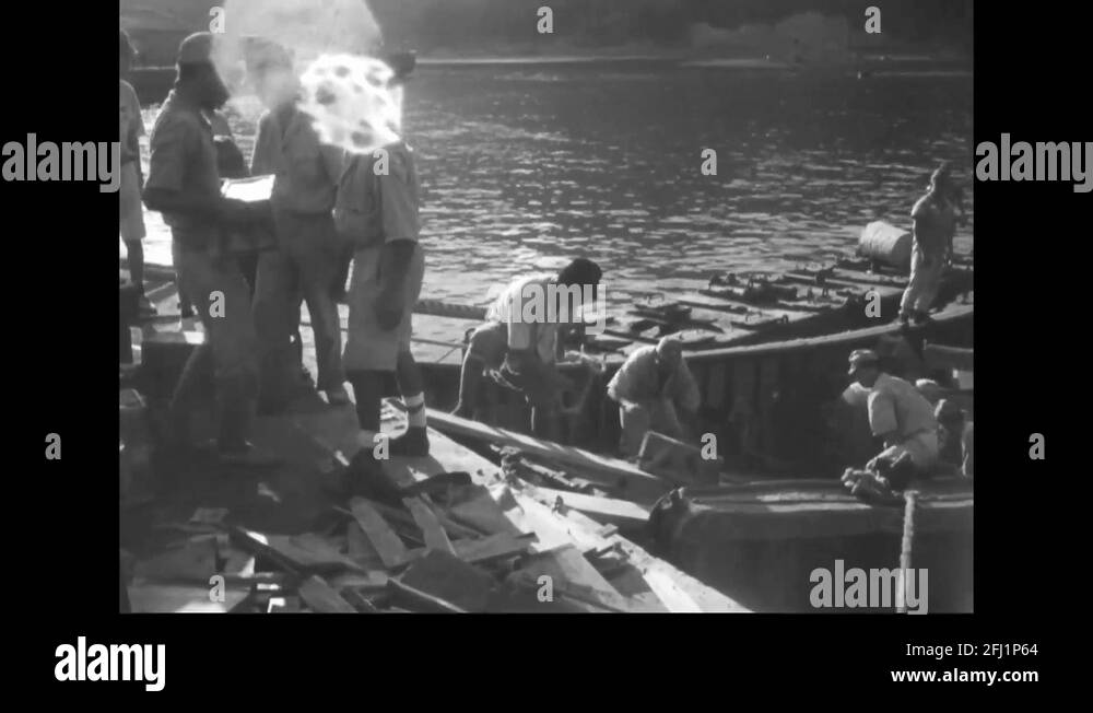 WW2 1945 - Supply is loaded in landing craft at Amami Oshima Stock ...