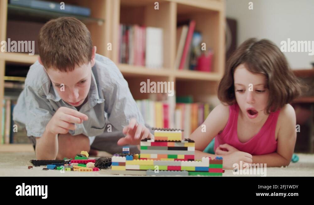 Two kids playing with lego bricks at home Stock Video Footage - Alamy