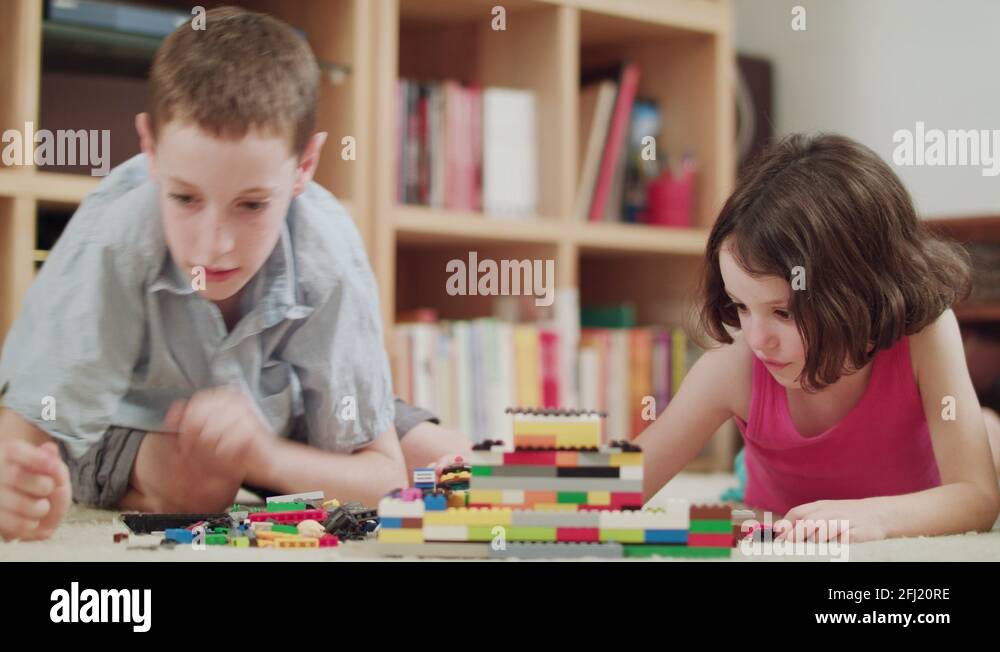 Two kids playing with lego bricks at home Stock Video Footage - Alamy