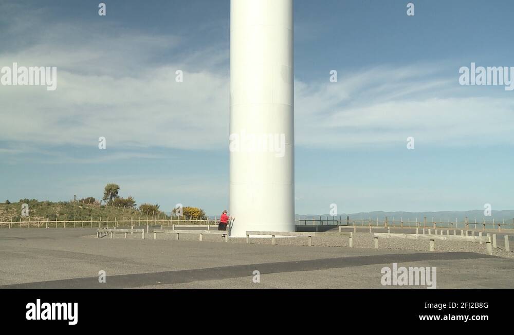 wind turbine tilt up from female at base Stock Video Footage - Alamy