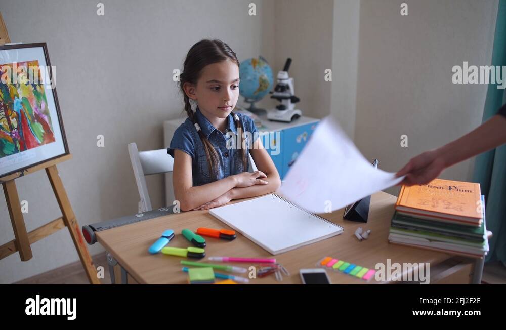 Schoolgirl in classroom, got a bad grade on test work, sad emotion ...