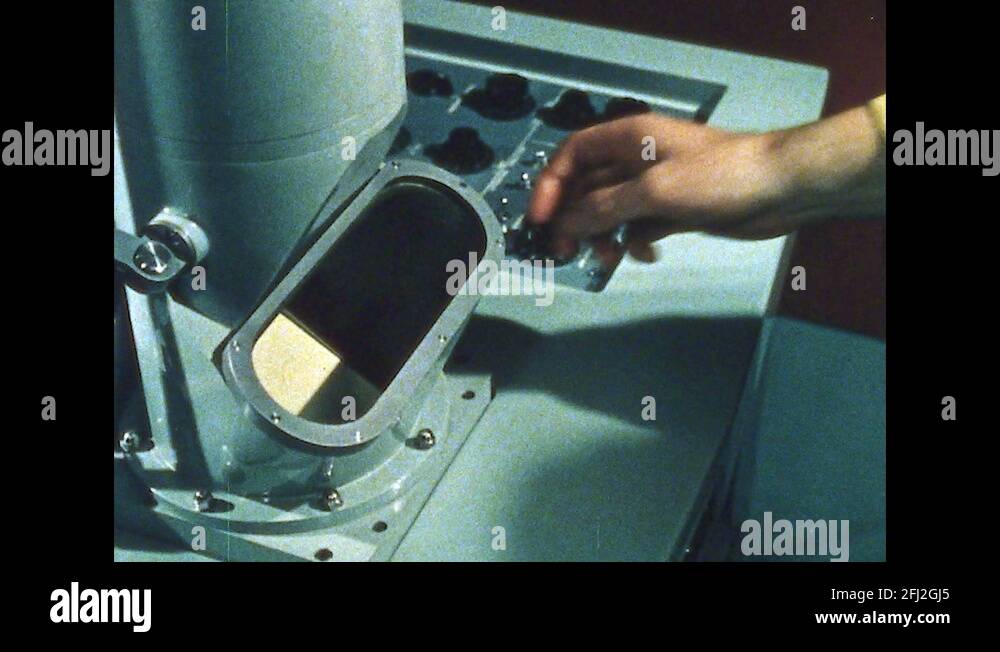 1960s: UNITED STATES: Viewing chamber on electron microscope. Hand ...