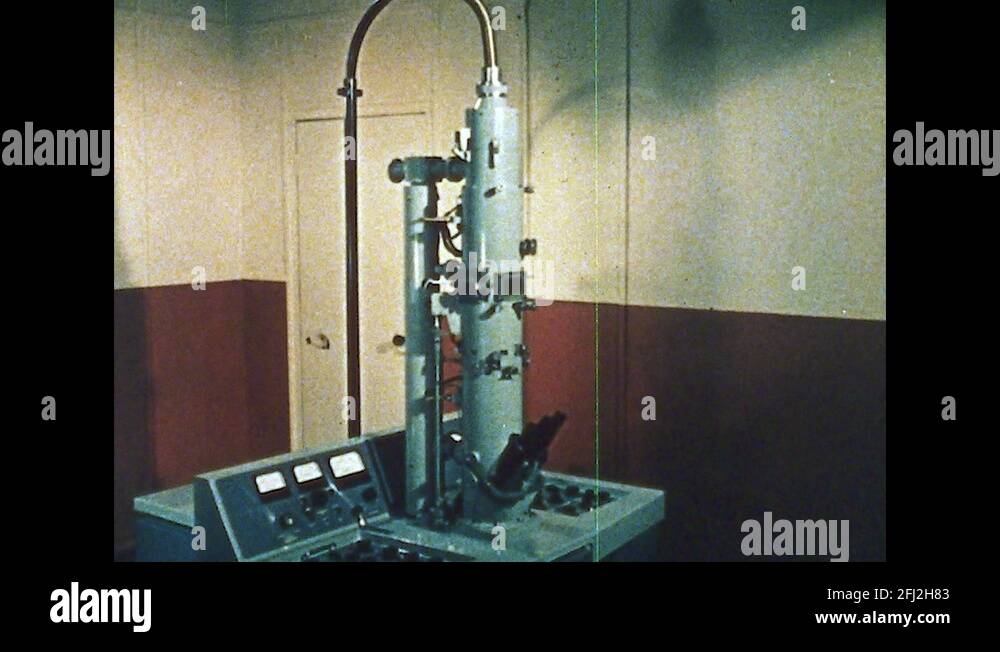 1960s: UNITED STATES: modern electron microscope. Cable on top of ...