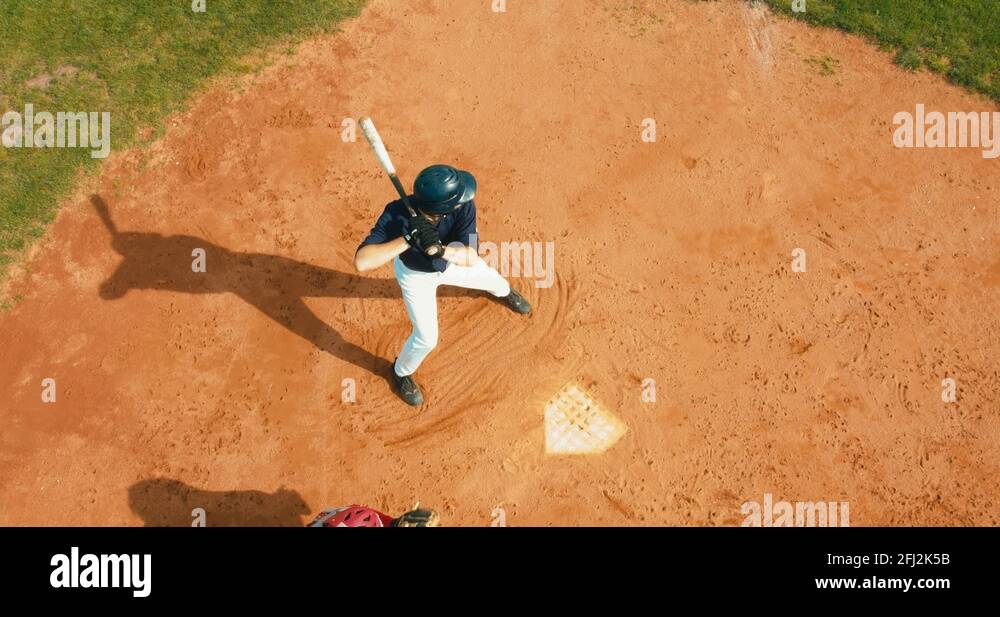 OVERHEAD CRANE Batter baseball player hits a ball over a home plate. 4K ...