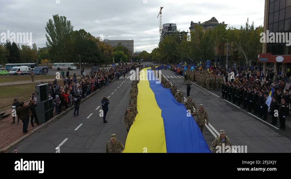 Military parade in streets of city with Ukrainian flag and marching ...