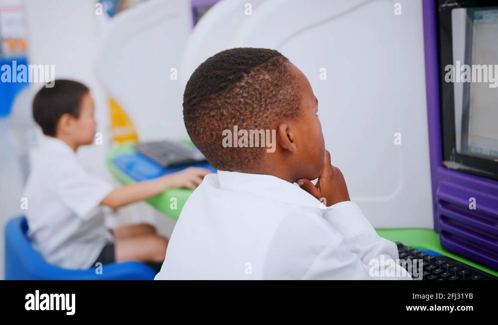 Young black boy using computer at a science centre Stock Video Footage ...