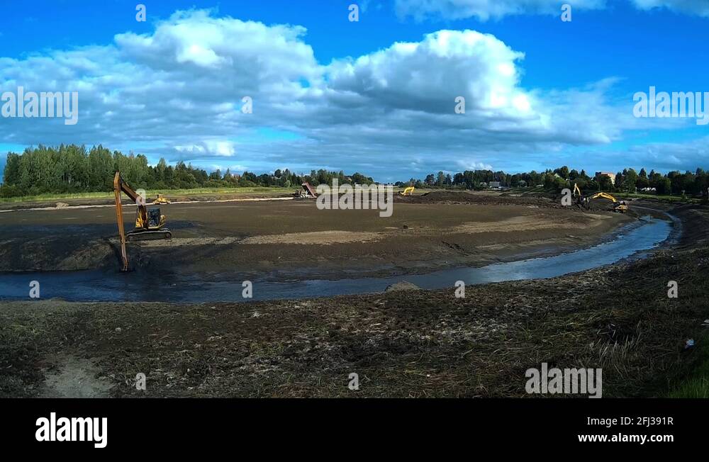 Excavators are working with Buckets to Clear Mud Sludge and Debris from ...