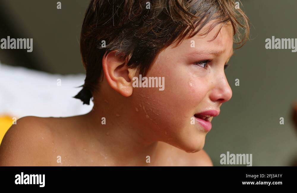 Tearful child sobs and cries. Young boy crying, candid authentic real ...