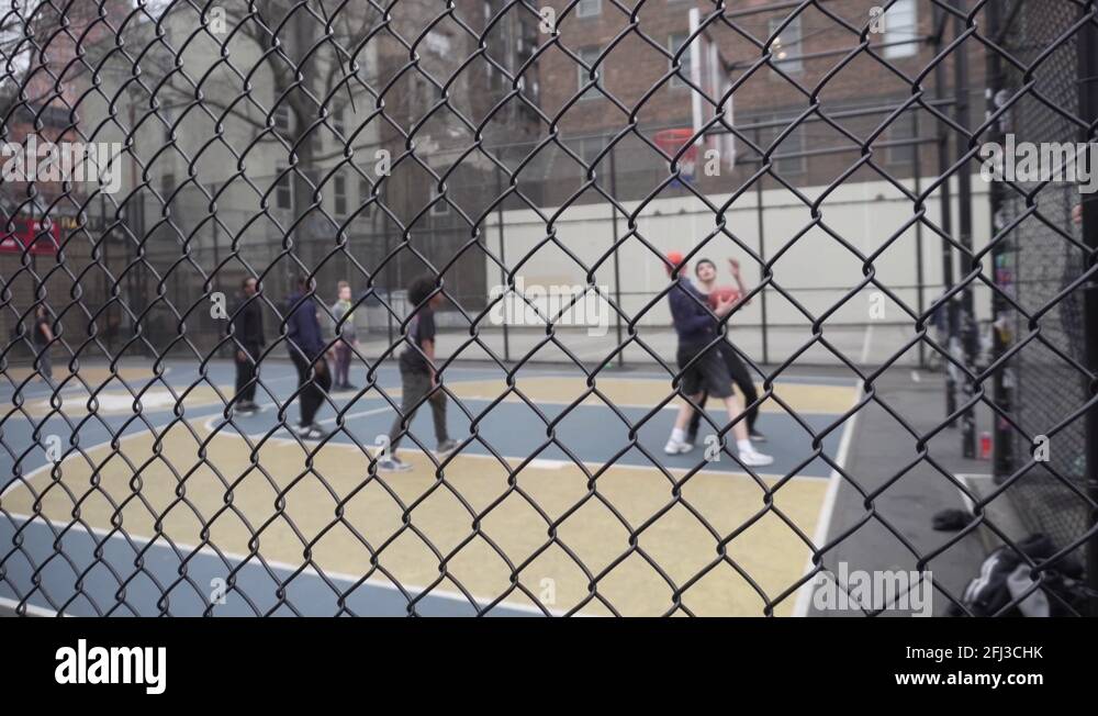 Kids playing basketball in a public basketball court in New York City ...