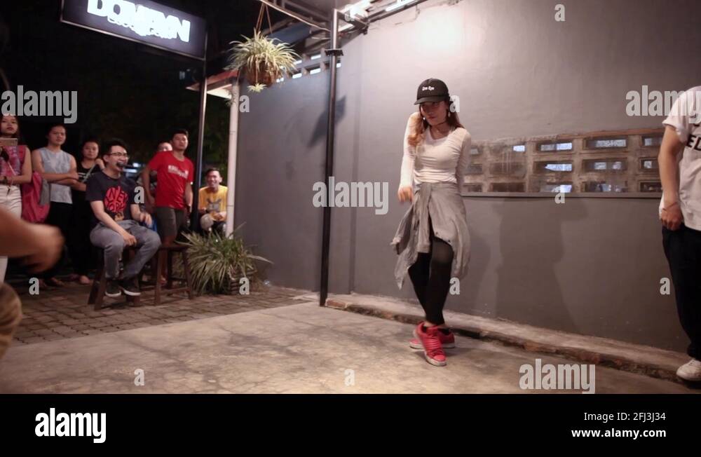 South east asian girl dances a modern hip hop dance in a freestyle ...