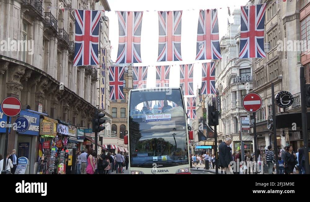 London bus with Union Jack flags hanging down Stock Video Footage - Alamy
