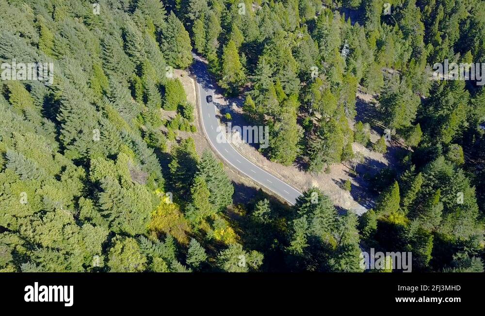 The camera follows a car down the road and then pans up to reveal a ...
