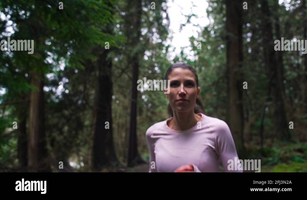 Woman runner jogging on forest path stops to enjoy nature Stock Video ...
