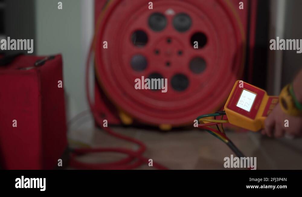 Fire suppression technician does a room / enclosure integrity test and ...