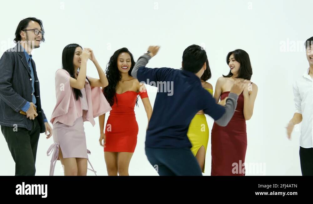 Asian people having fun dancing like crazy at white background Stock ...