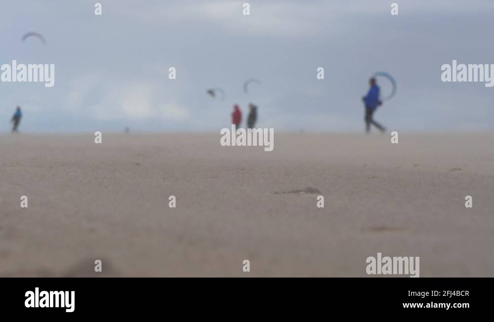 People walking on a nice sunny windy day on the beach, with some Stock ...