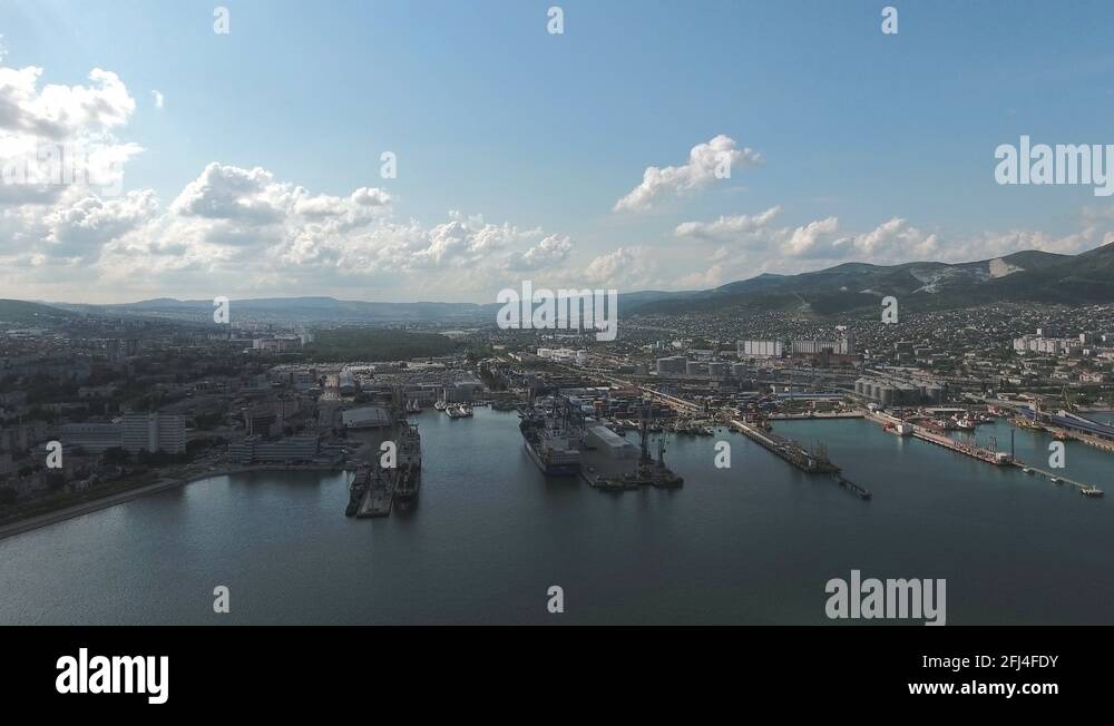Industrial seaport, top view. Port cranes and cargo ships and barges ...
