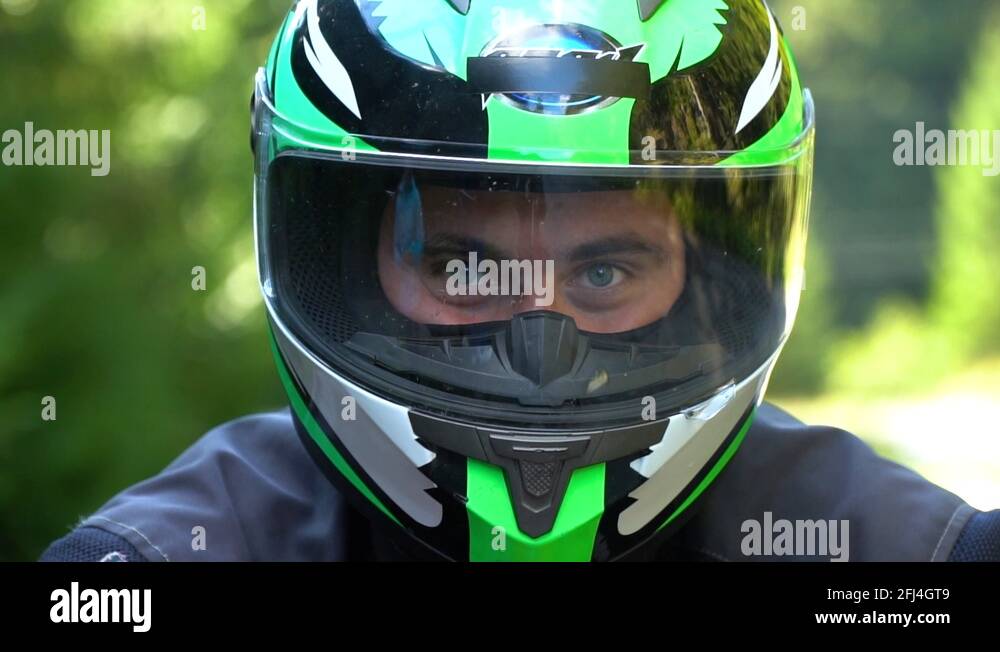 A guy on a motorcycle. Young handsome guy with his motorcycle in the ...