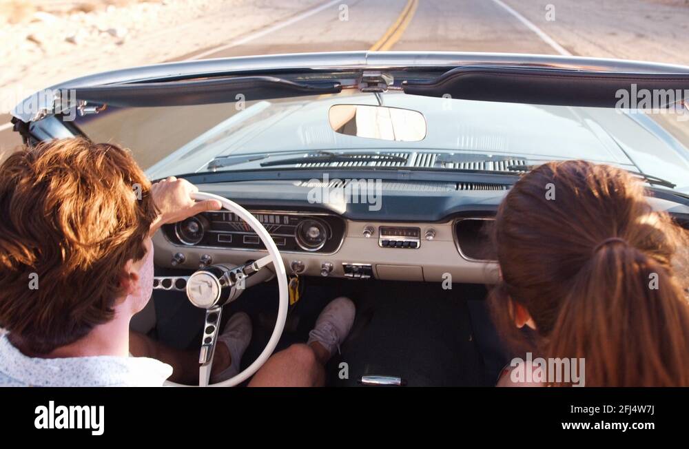 Young white couple driving open top car, elevated back view Stock Video ...