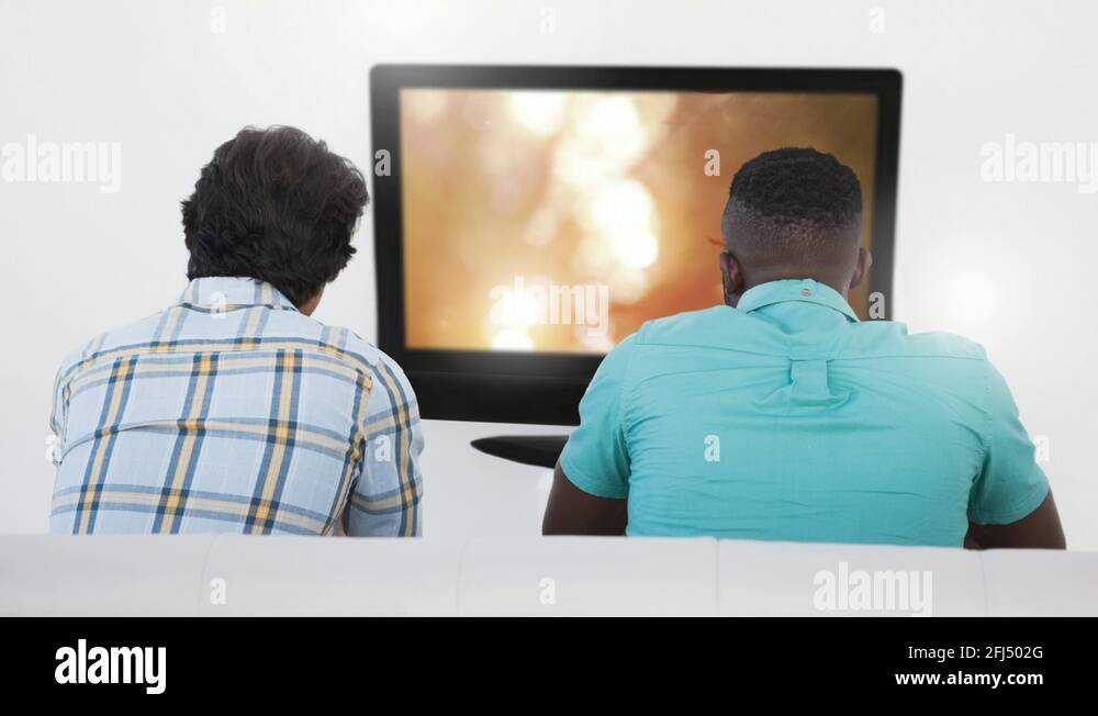 Two men watching falling autumn leaves on television 4k Stock Video ...