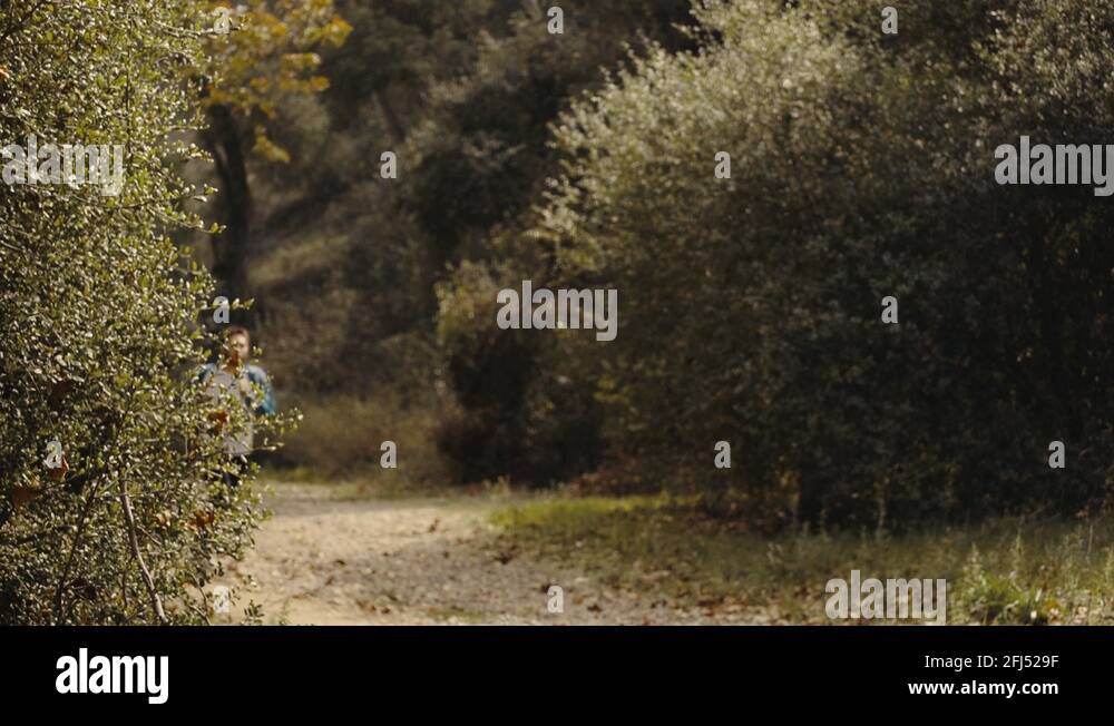 Cinematic scene of jogger man running left to right. Man wears blue ...