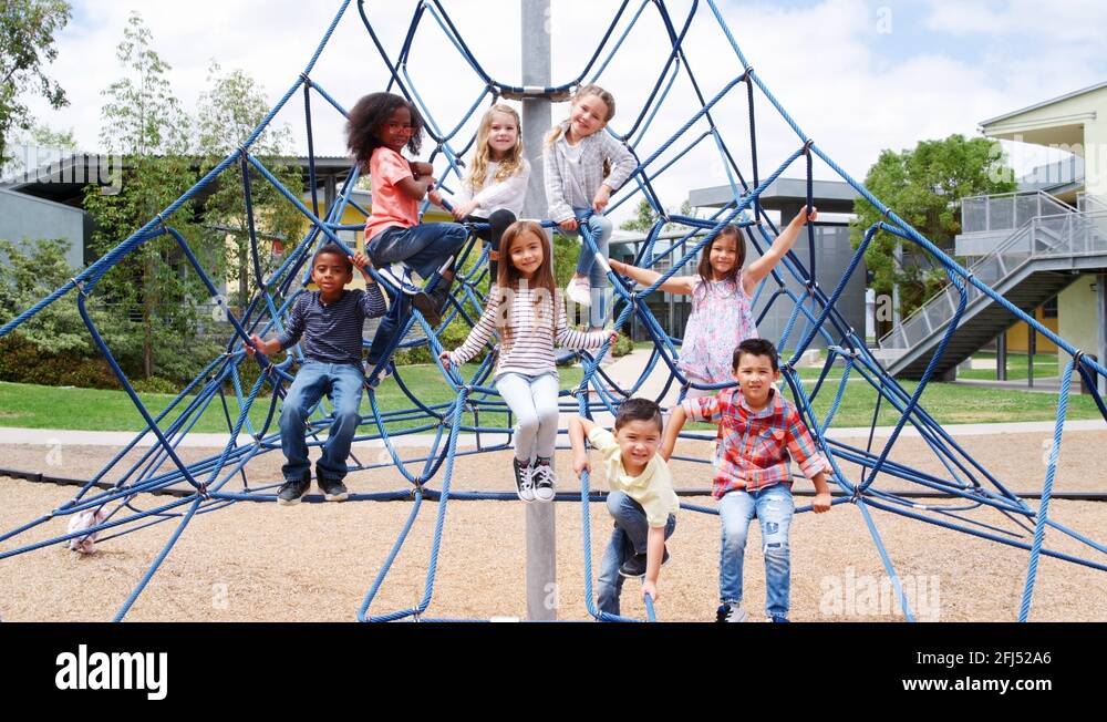 Elementary school kids on climbing net in school playground Stock Video ...