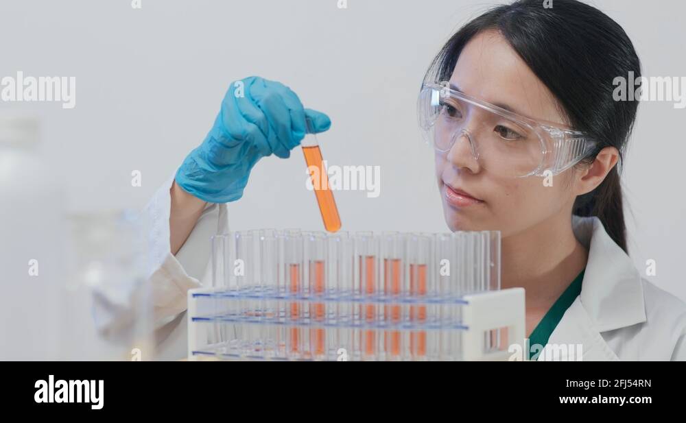 Scientist making observation on test tube Stock Video Footage - Alamy